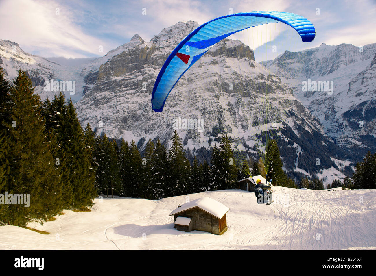 paragliding over Alps with snow and barn looking towards the Wetterhorn ...