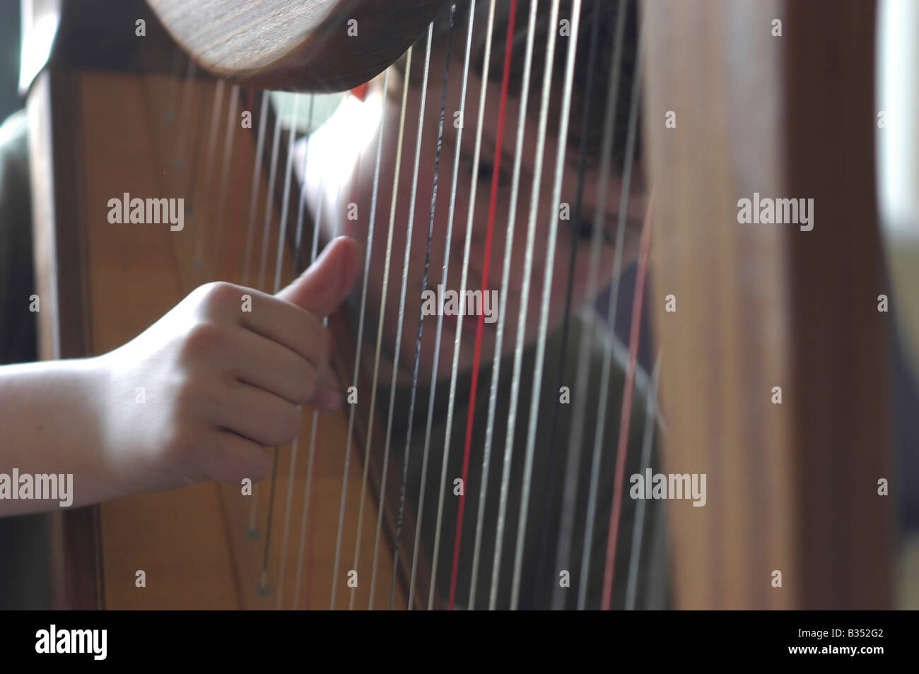 boy playing the harp Stock Photo - Alamy