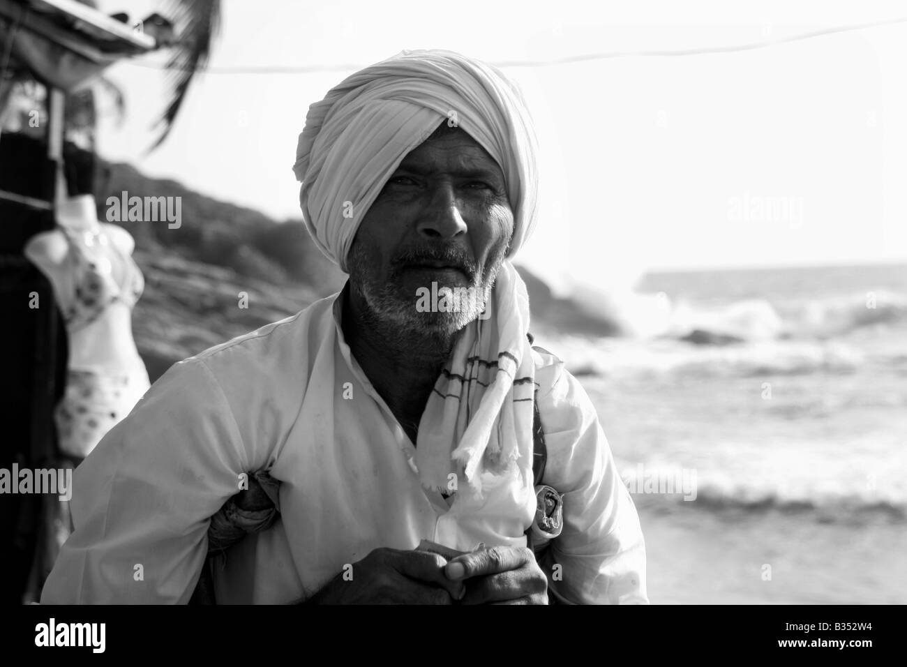 A poor old man in front of a shop at kovalam beach Stock Photo - Alamy
