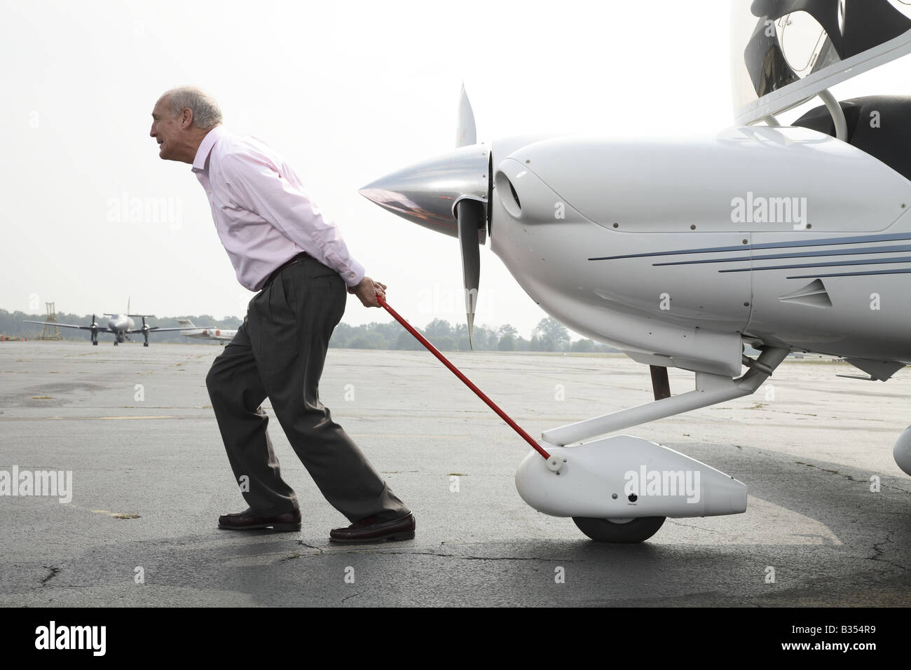 Man pulling airplane hi-res stock photography and images - Alamy
