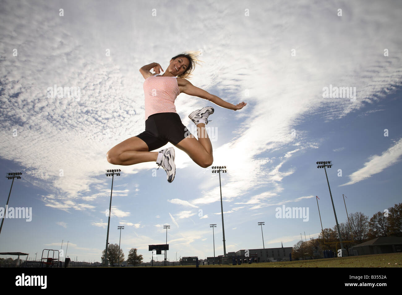 female runner jumping Stock Photo - Alamy