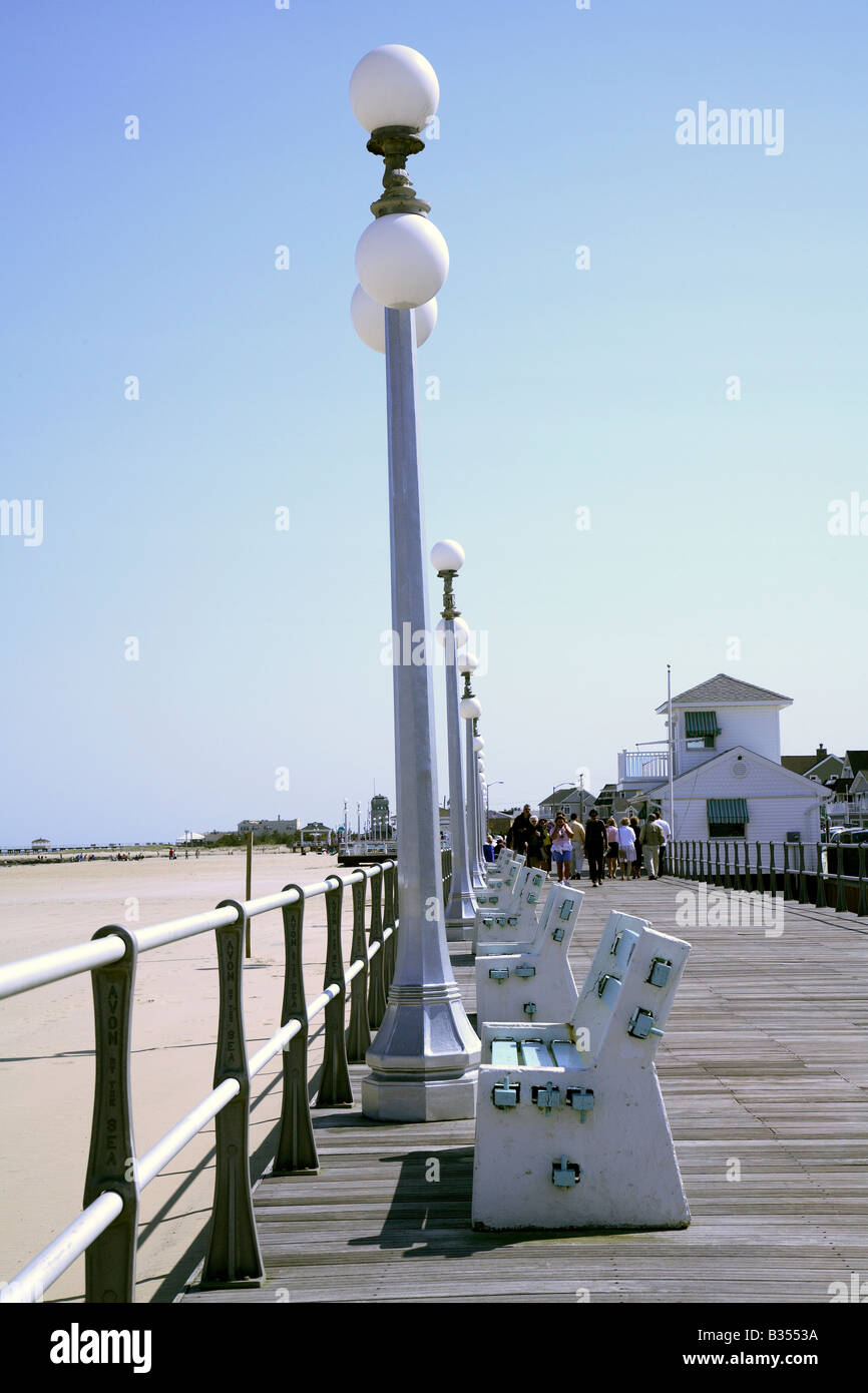 Wooden boardwalk with rows of benches and light posts Stock Photo - Alamy