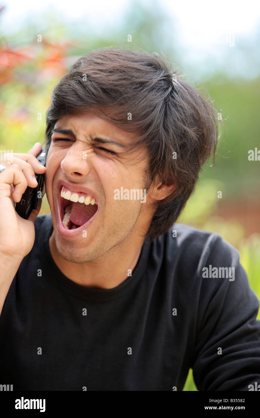 Young Man Shouting on Mobile Phone Model Released Stock Photo - Alamy