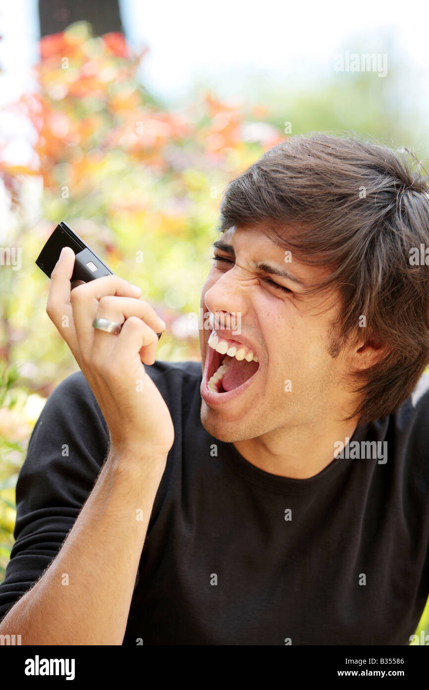 Young Man Shouting on Mobile Phone Model Released Stock Photo - Alamy