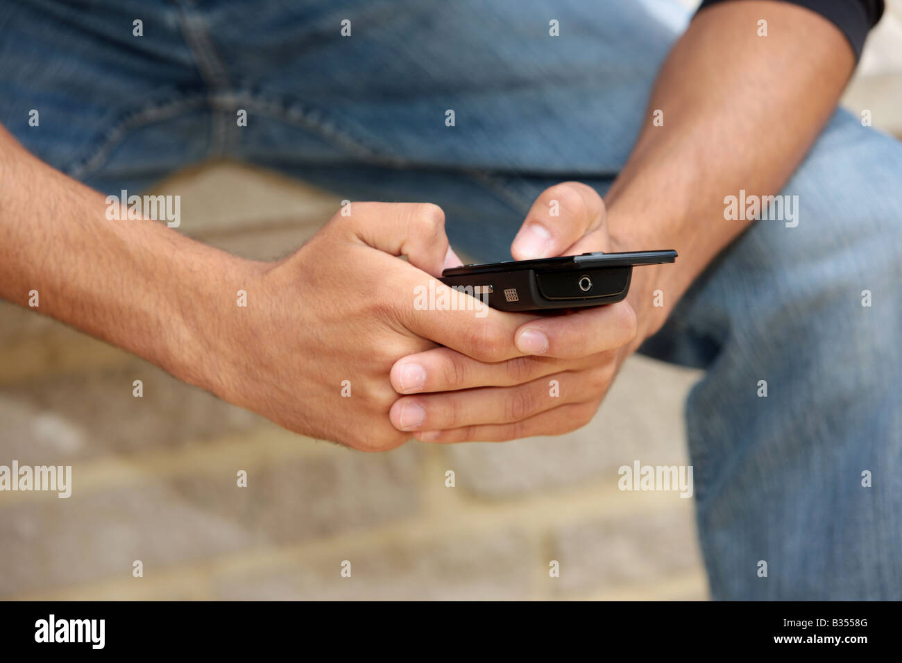 Young Man Texting on Mobile Phone Model Released Stock Photo - Alamy