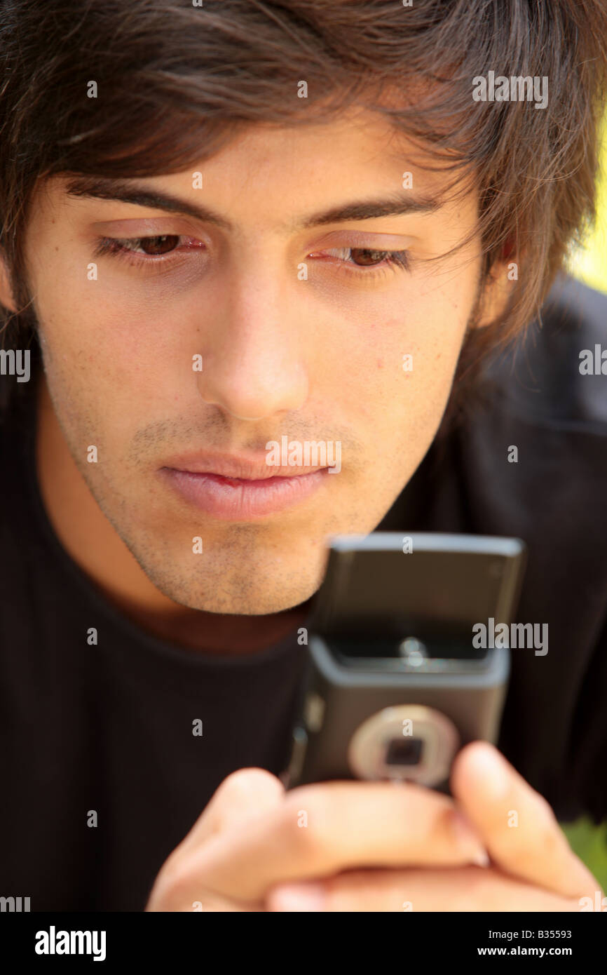 Young Man Texting on Mobile Phone Model Released Stock Photo - Alamy