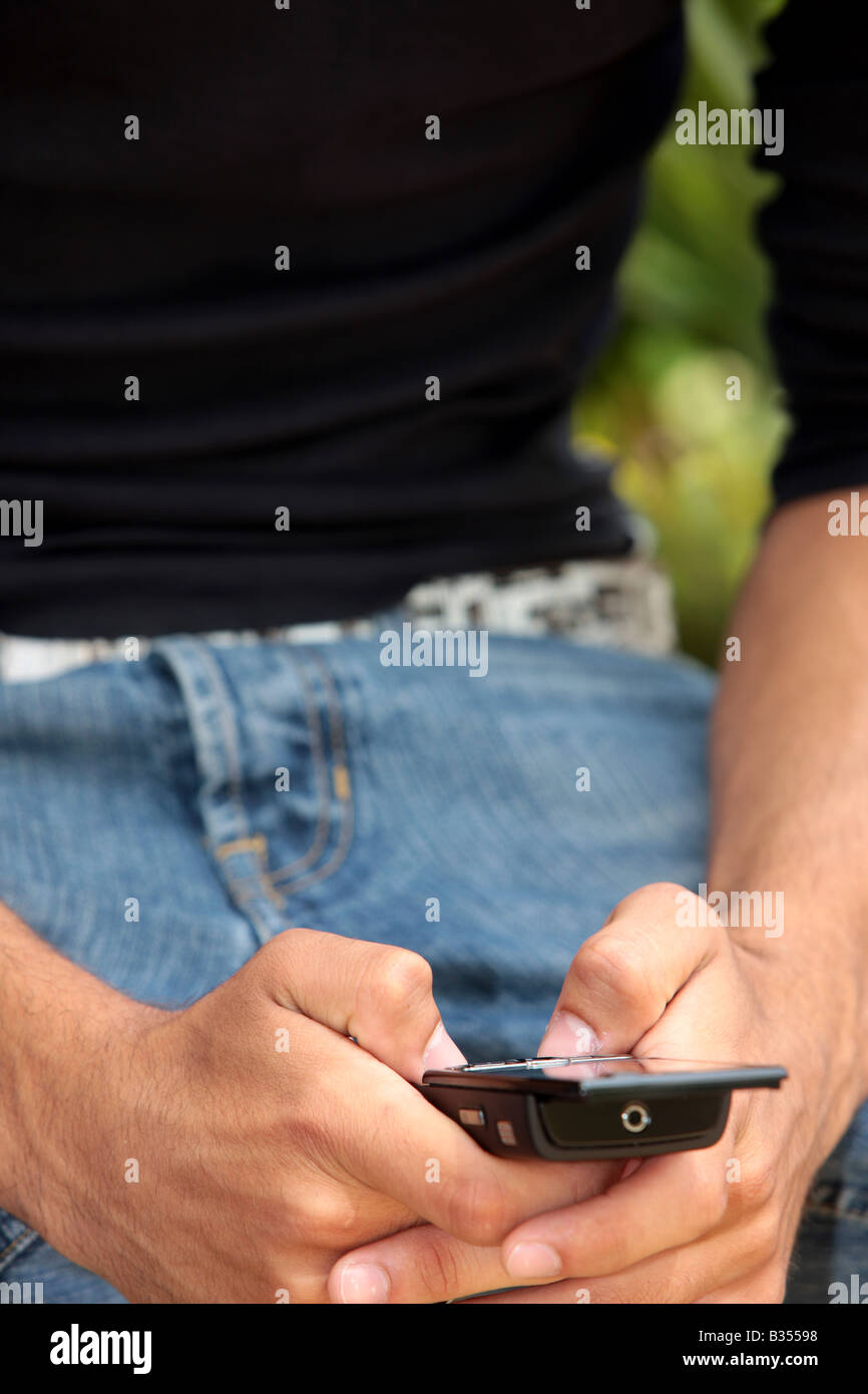 Young Man Texting on Mobile Phone Model Released Stock Photo - Alamy