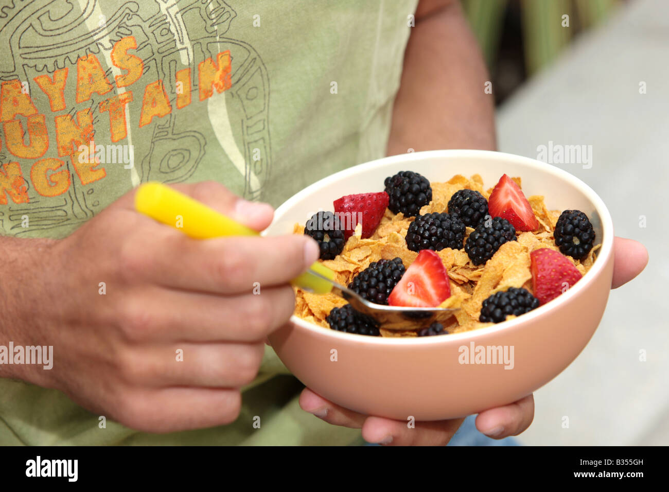 Young Man Eating Cornflakes with Berries Model Released Stock Photo - Alamy