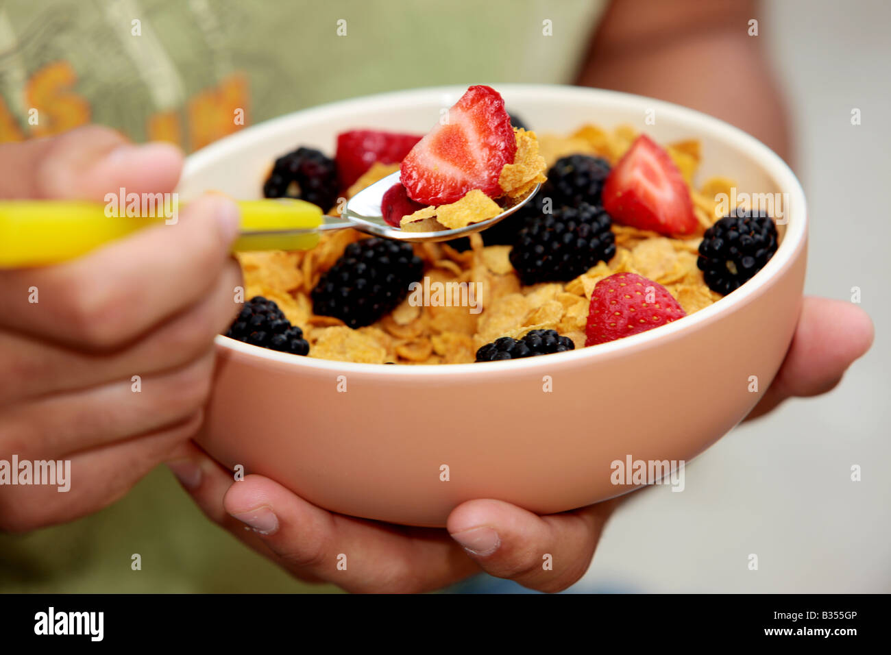 Young Man Eating Cornflakes with Berries Model Released Stock Photo - Alamy