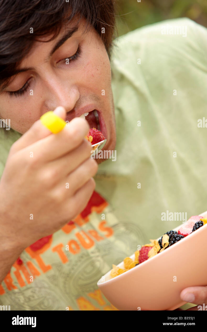 Young Man Eating Cornflakes with Berries Model Released Stock Photo - Alamy