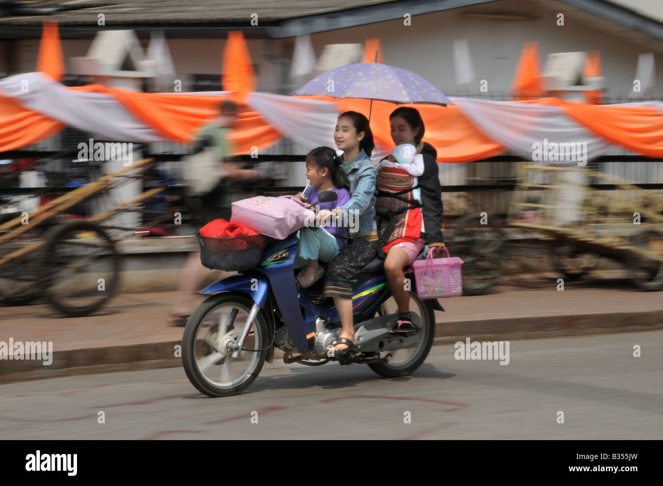 Two wheel riding family Stock Photo - Alamy