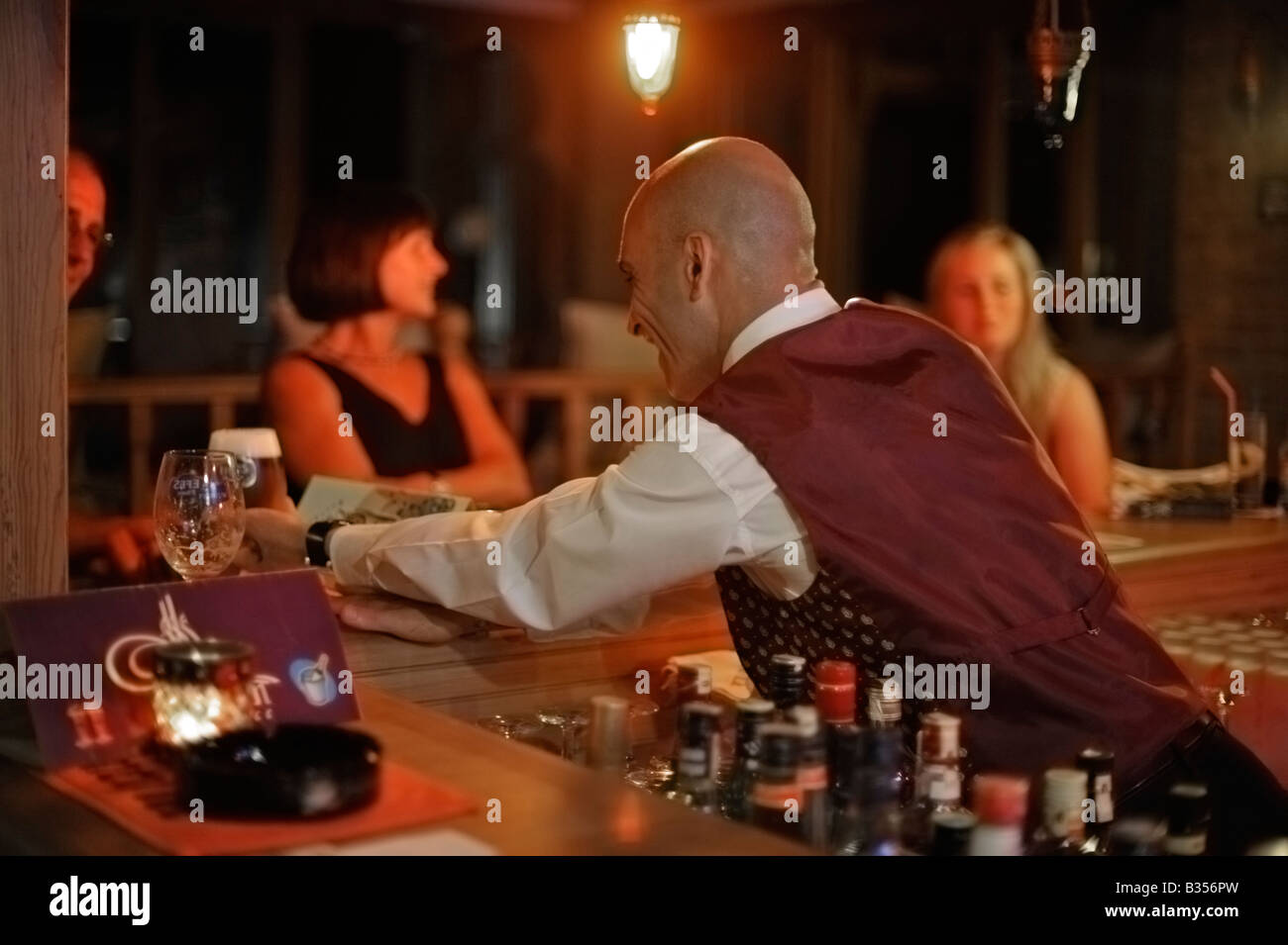 barman in hotel serving night time drinks Stock Photo - Alamy