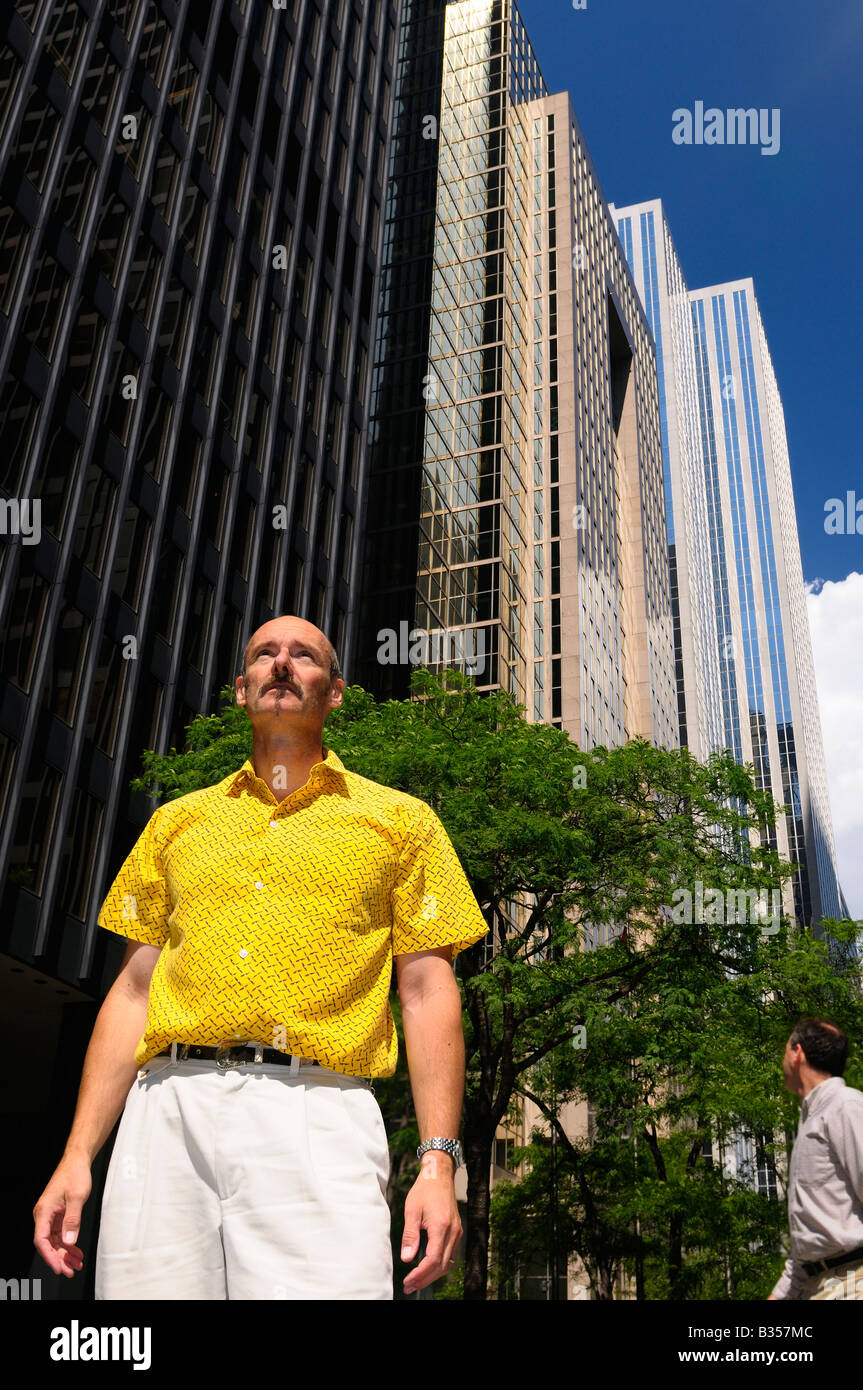Man looking up at skyscraper high rise towers in downtown financial ...