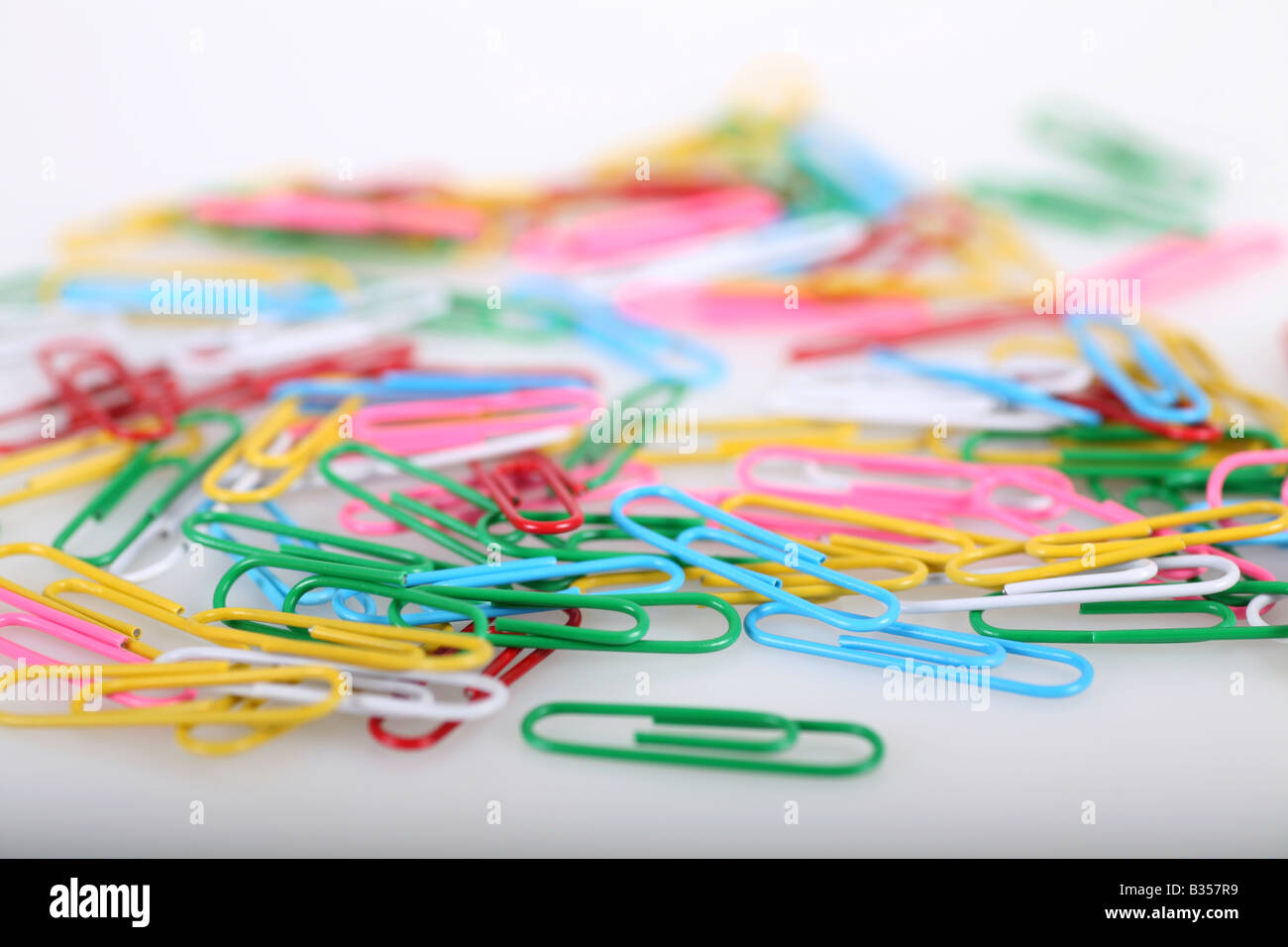 Coloured paper clips on a white background Stock Photo - Alamy