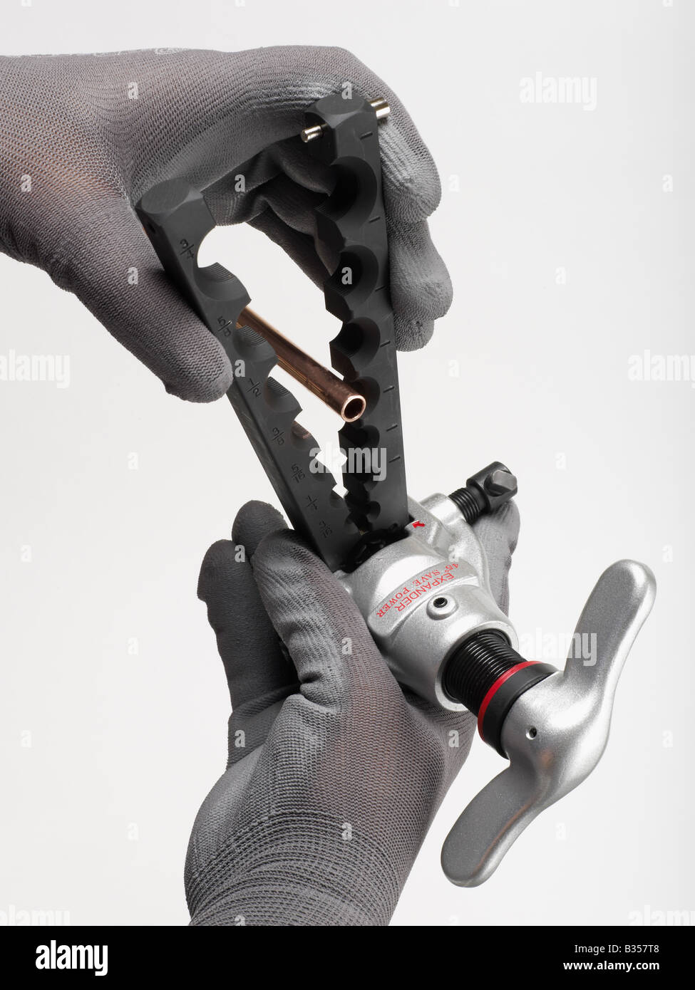 PLUMBER OPERATING AN ECCENTRIC COPPER PIPE FLARING TOOL Stock Photo - Alamy