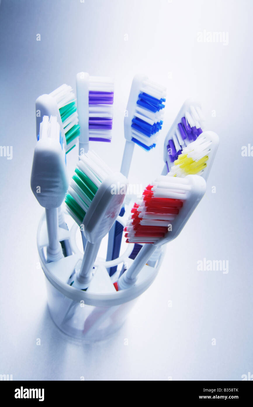 Toothbrushes in Plastic Cup Stock Photo - Alamy