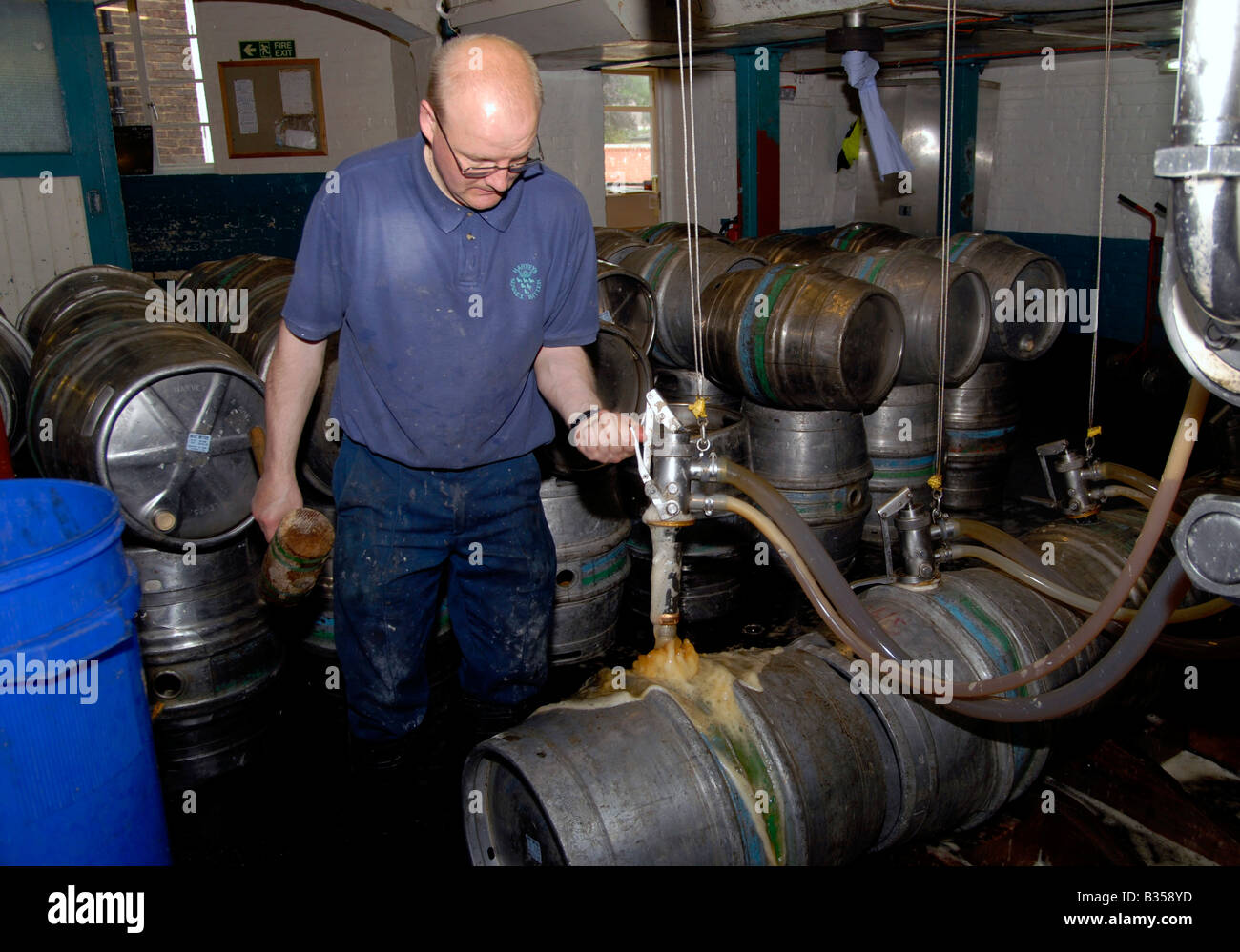 Beer poured into casks at Harveys Brewery, a family owned business ...