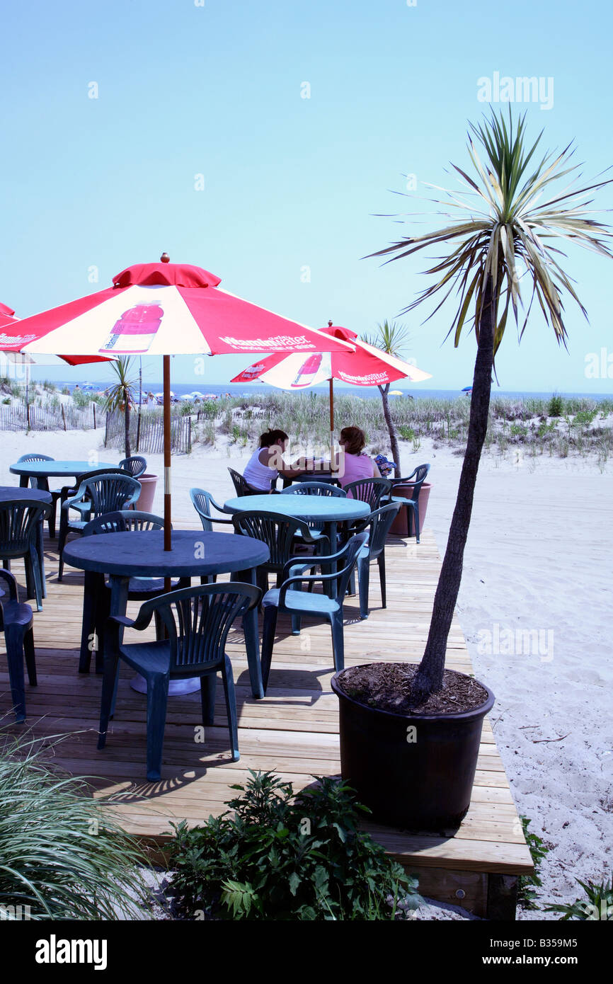 Outdoor beach cafe with small round bistro tables Stock Photo - Alamy