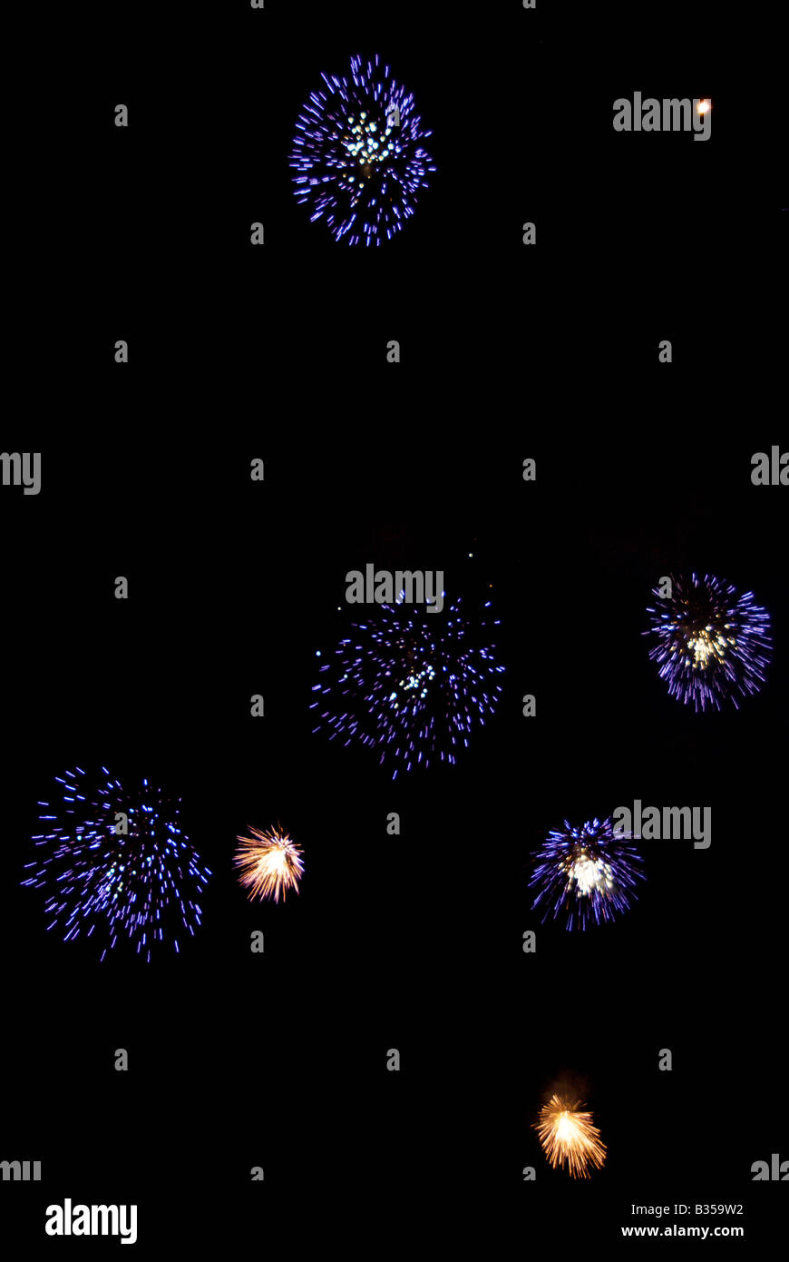 Small blue fireworks explode simultaneously over Lake Suwa as part of ...