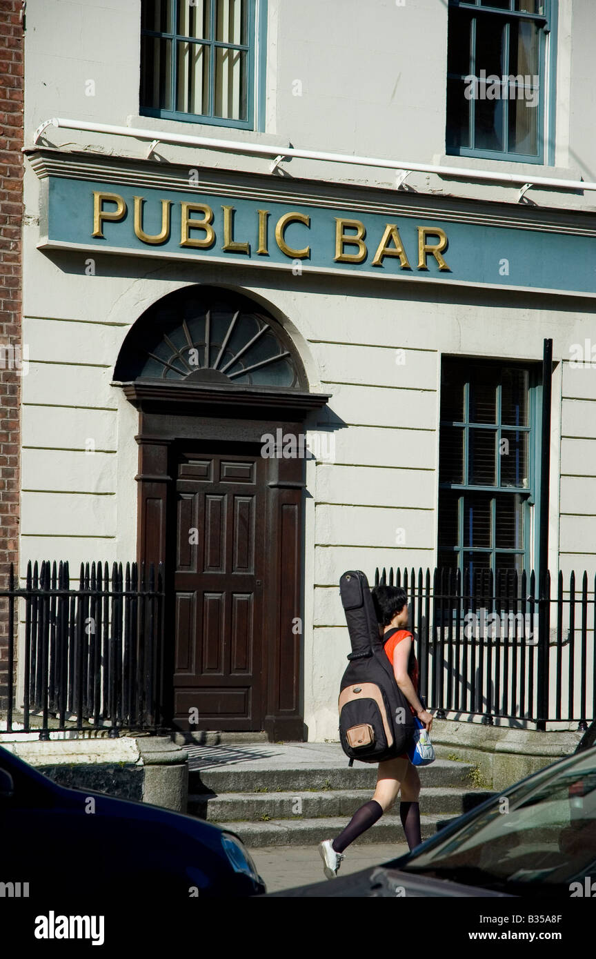 Young girl walks by a bar in Dublin city centre, Ireland Stock Photo ...