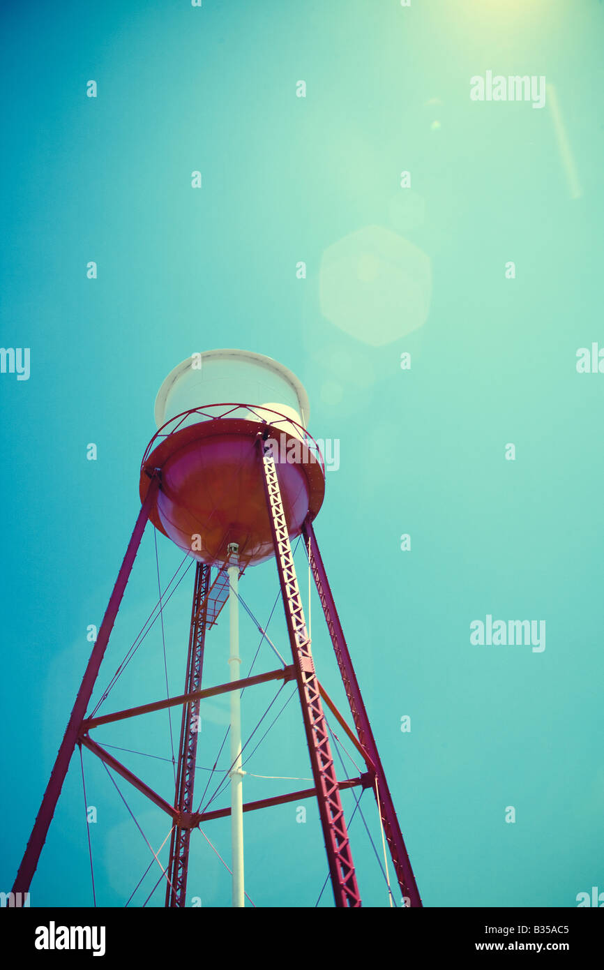 Red and white water tower in west Texas isolated in the corner of the ...