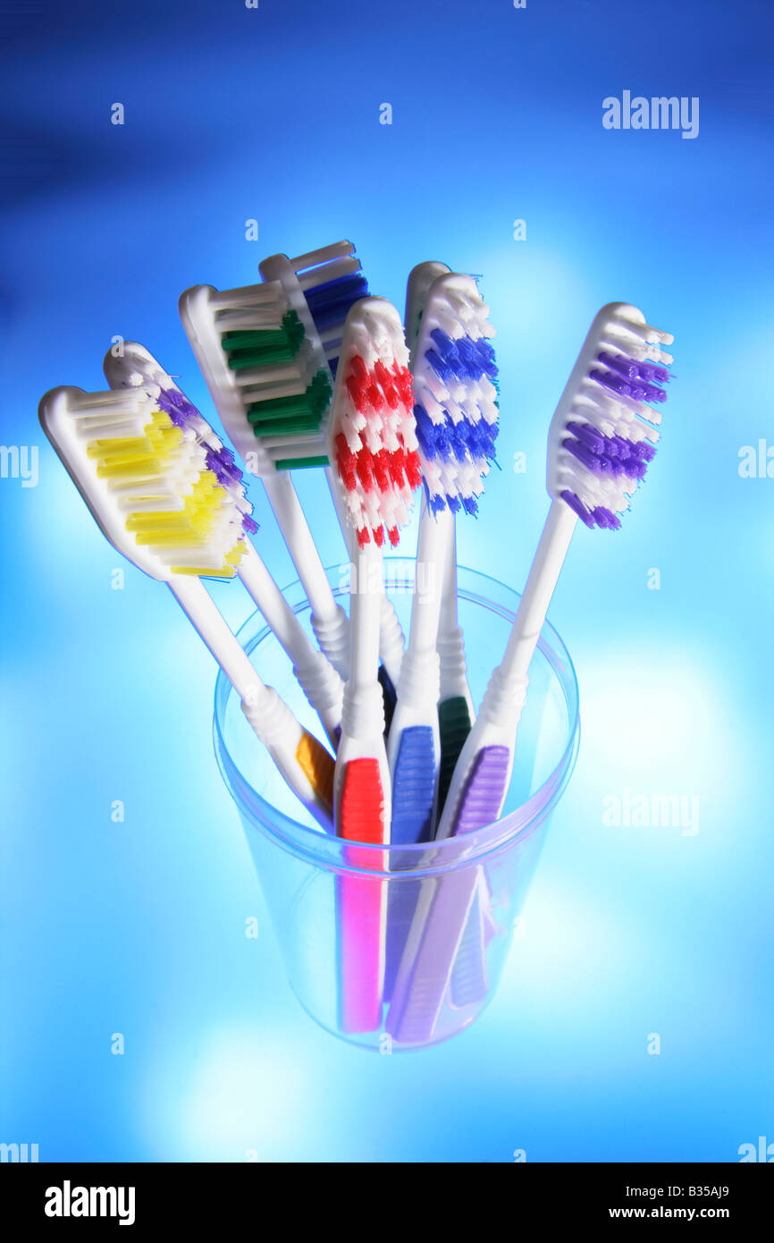 Toothbrushes in Plastic Cup Stock Photo - Alamy