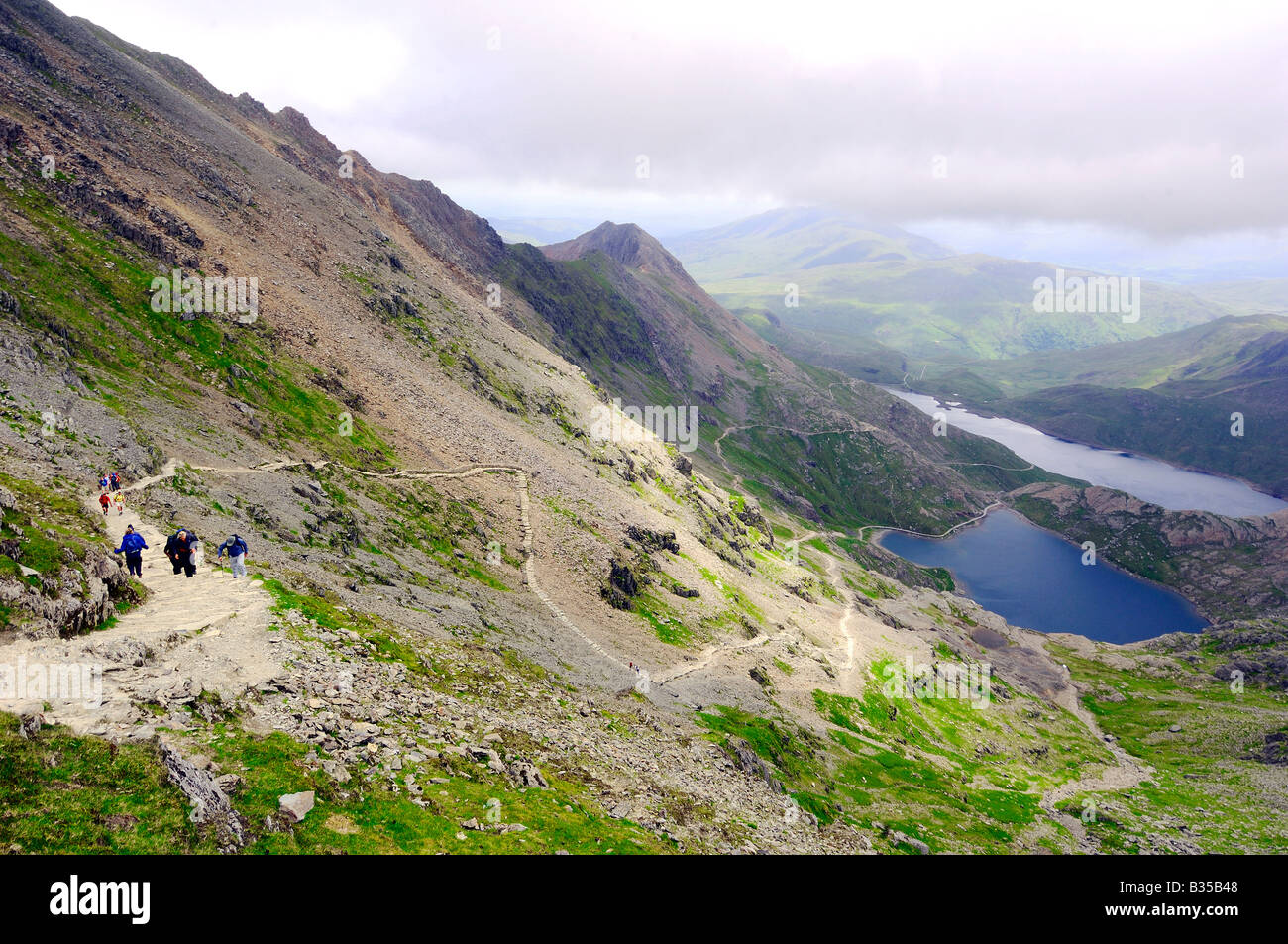 Several people walking along the Pyg Track between Llyn Glaslyn and the ...