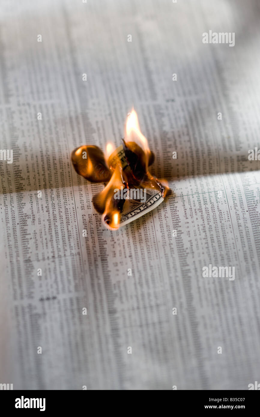 ONE US DOLLAR BILL BURNING ON FINANCIAL PAPER Stock Photo - Alamy