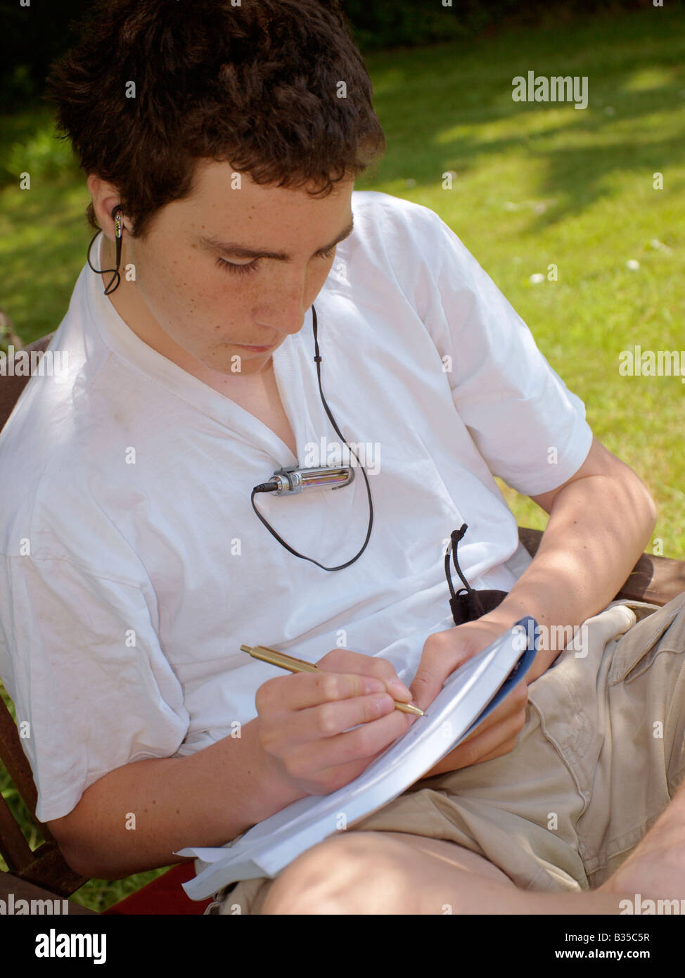 Multi tasking student outdoor learning Stock Photo - Alamy