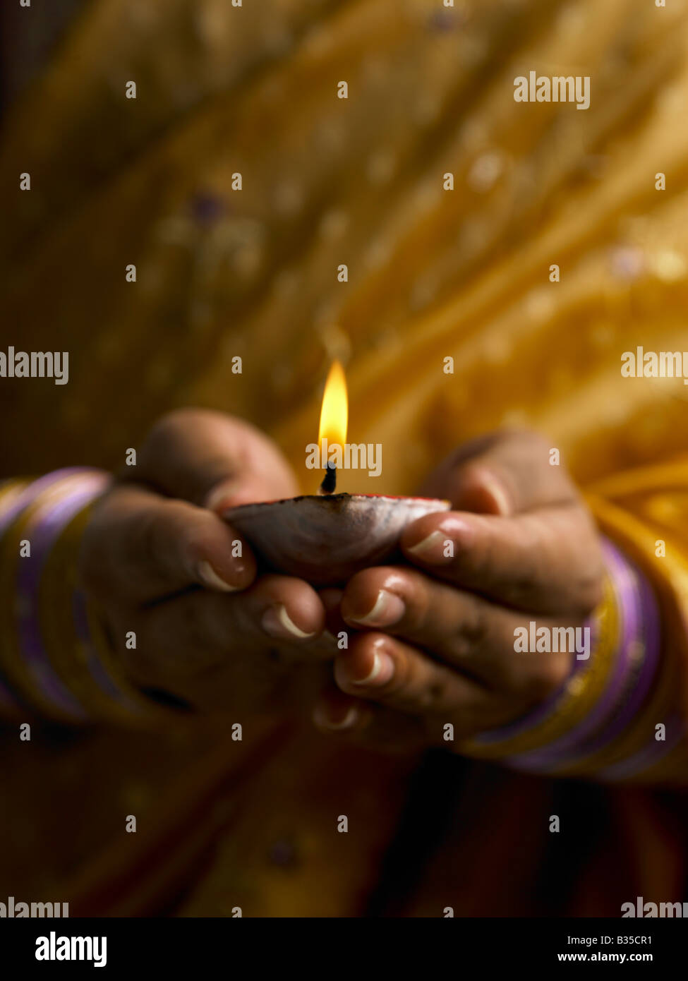 A woman hands holding oil lamp Stock Photo - Alamy
