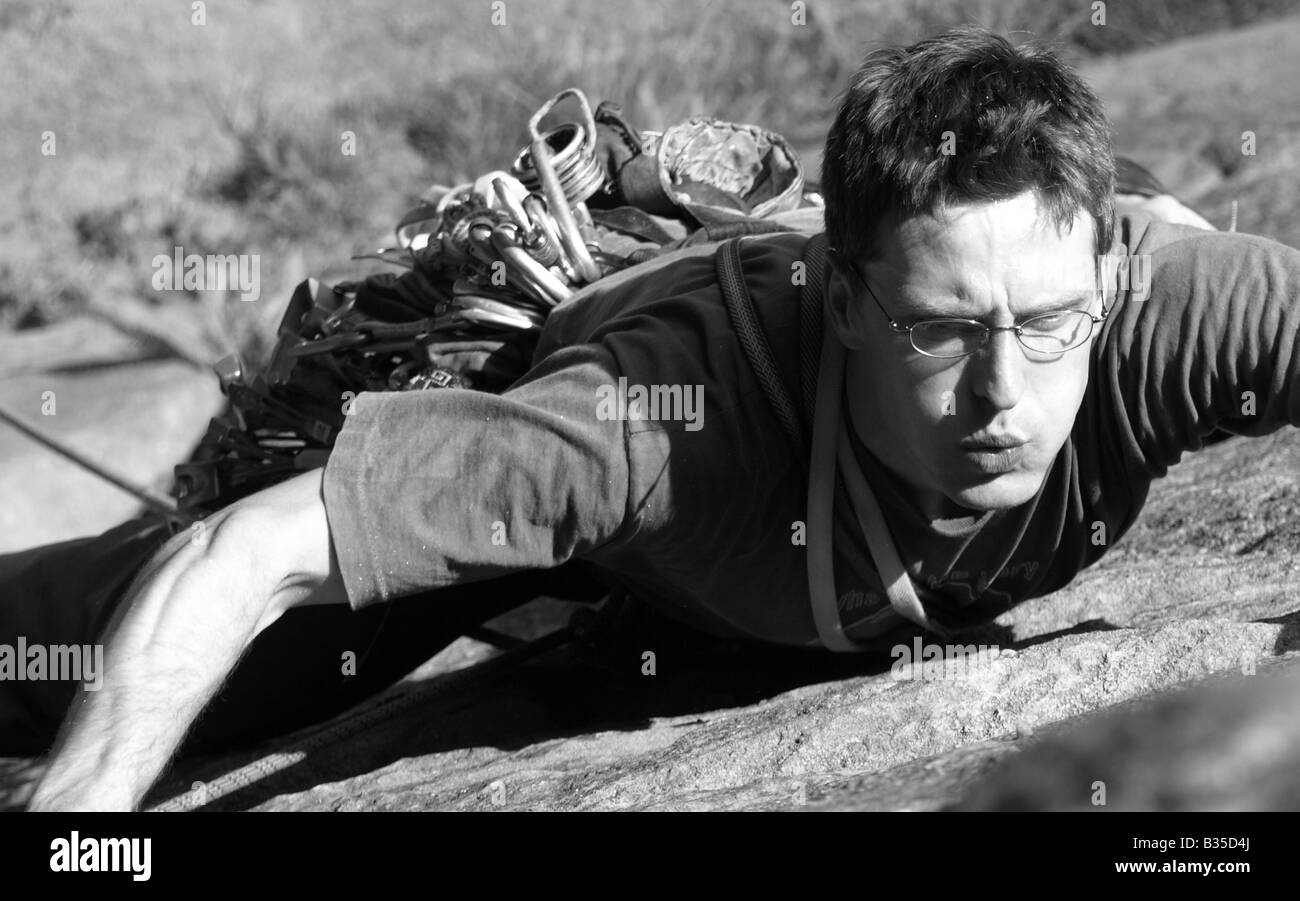 A young male climber trying hard on a tough climb Stock Photo - Alamy