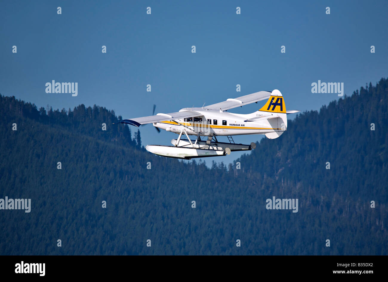 Commercial seaplane flying over Burrard Inlet, Vancouver, British ...