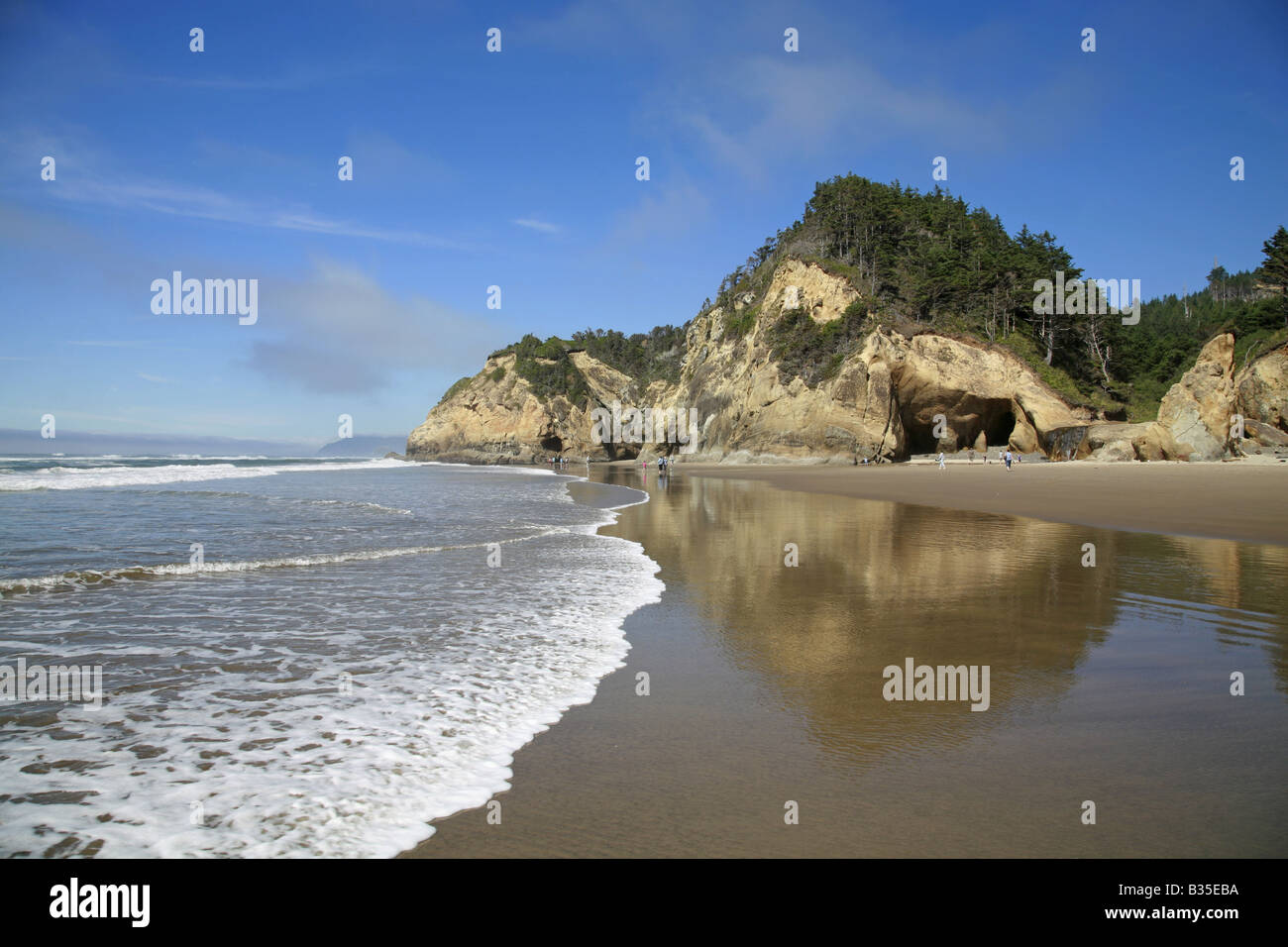Visitors walk along the beautiful beach at Hug Point State Park near ...