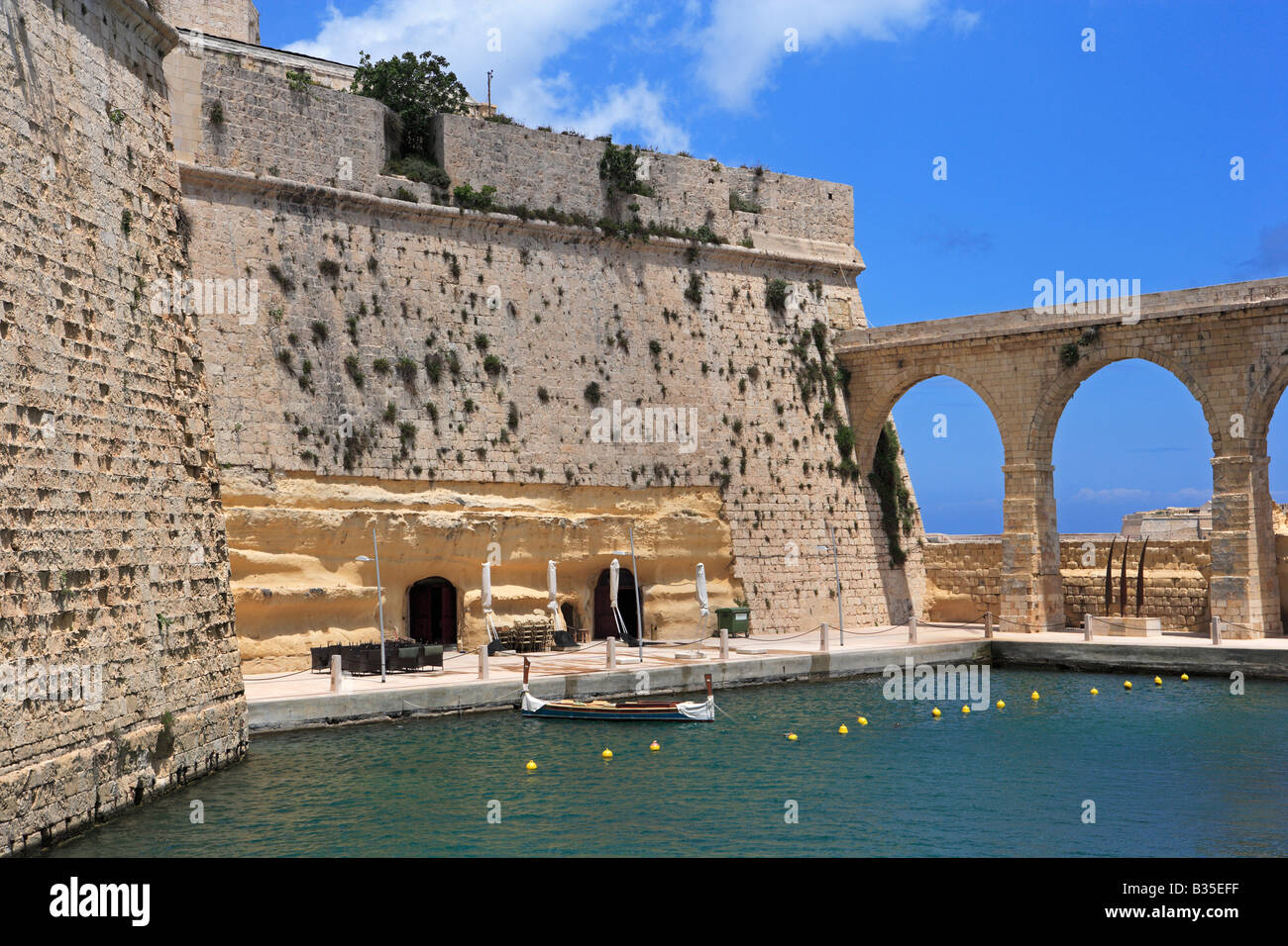 Fort St Angelo fortifications with Dghajsa or traditional Maltese ...