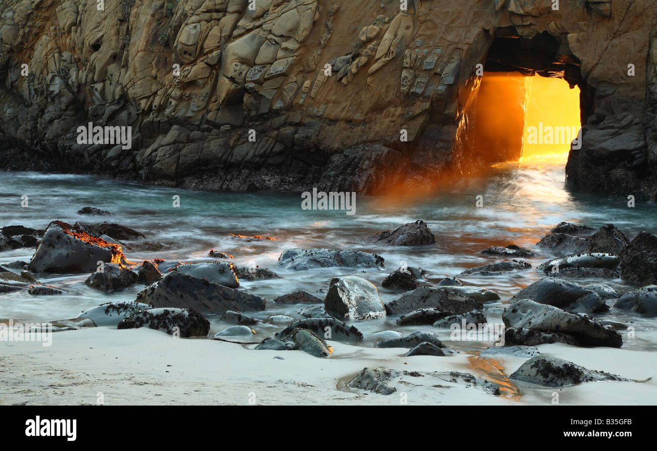 Beam orange light rock ocean arch hi-res stock photography and images ...