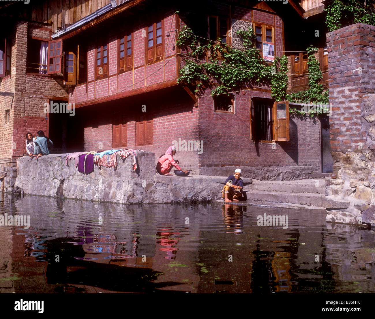 Canalside houses and local women washing laundry at Srinagar in the ...
