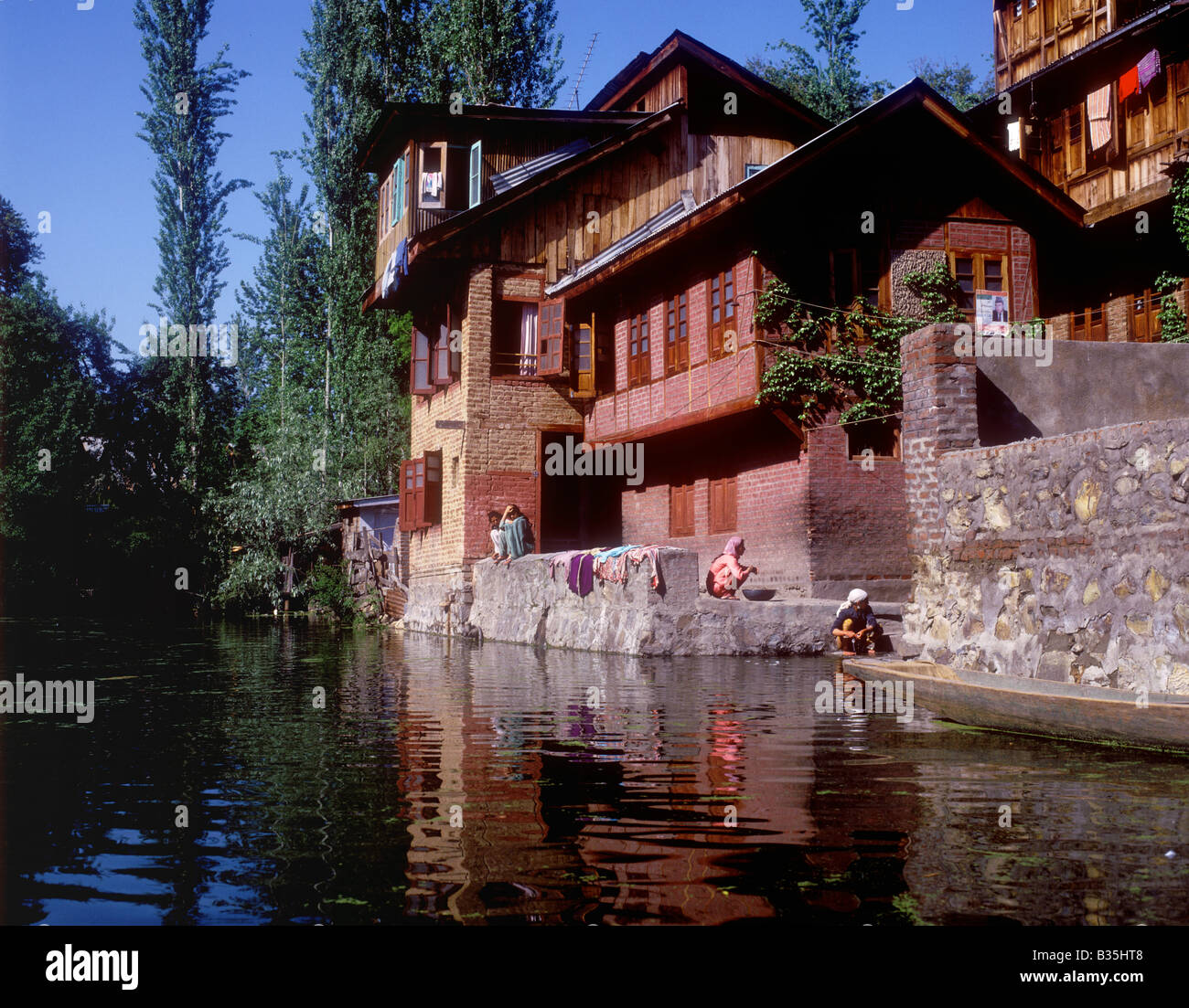 Canalside houses and local women washing laundry at Srinagar in the ...