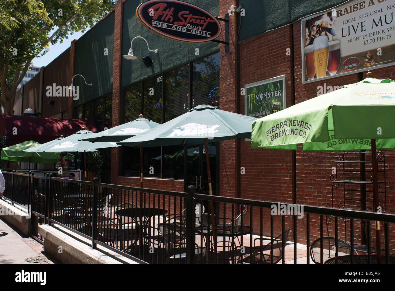 A group of covered tables on a bar patio Stock Photo - Alamy