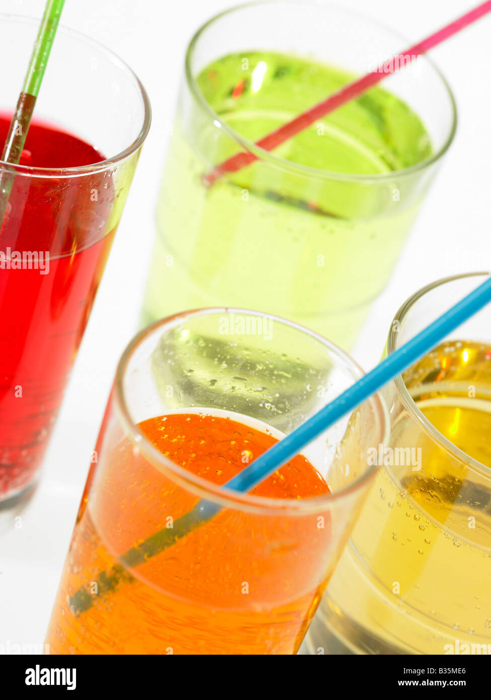 Four Glasses of fizzy drinks with straws Stock Photo - Alamy