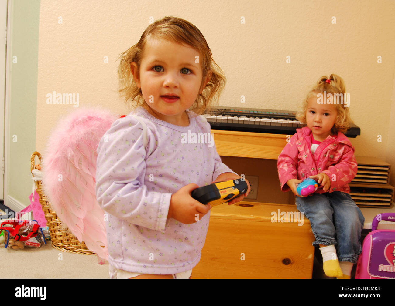 Two girls playing with toys Stock Photo - Alamy