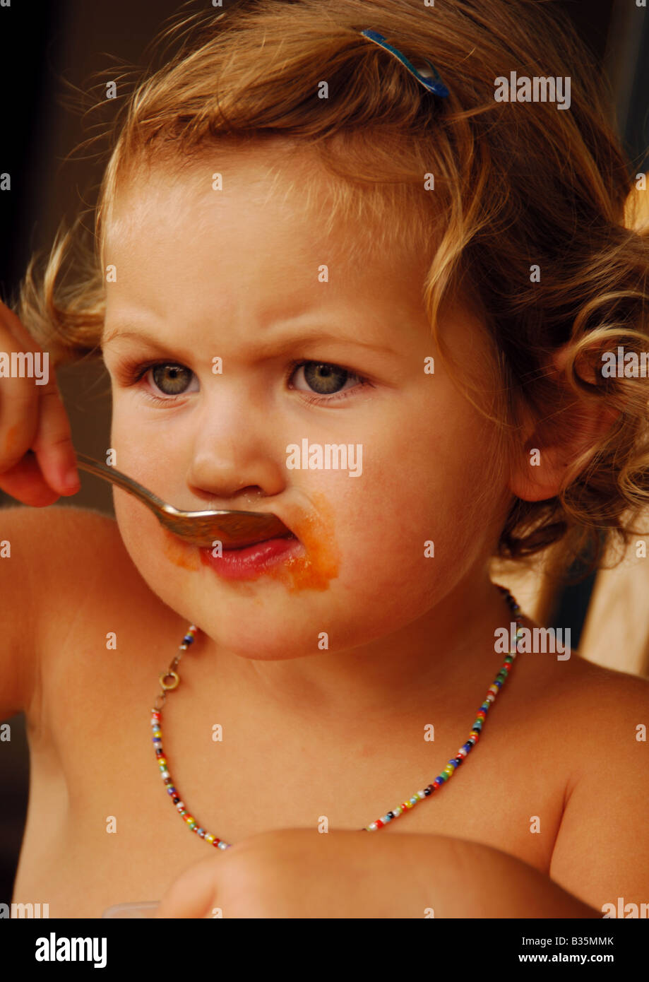 Close-up of a girl eating jam with a spoon Stock Photo - Alamy