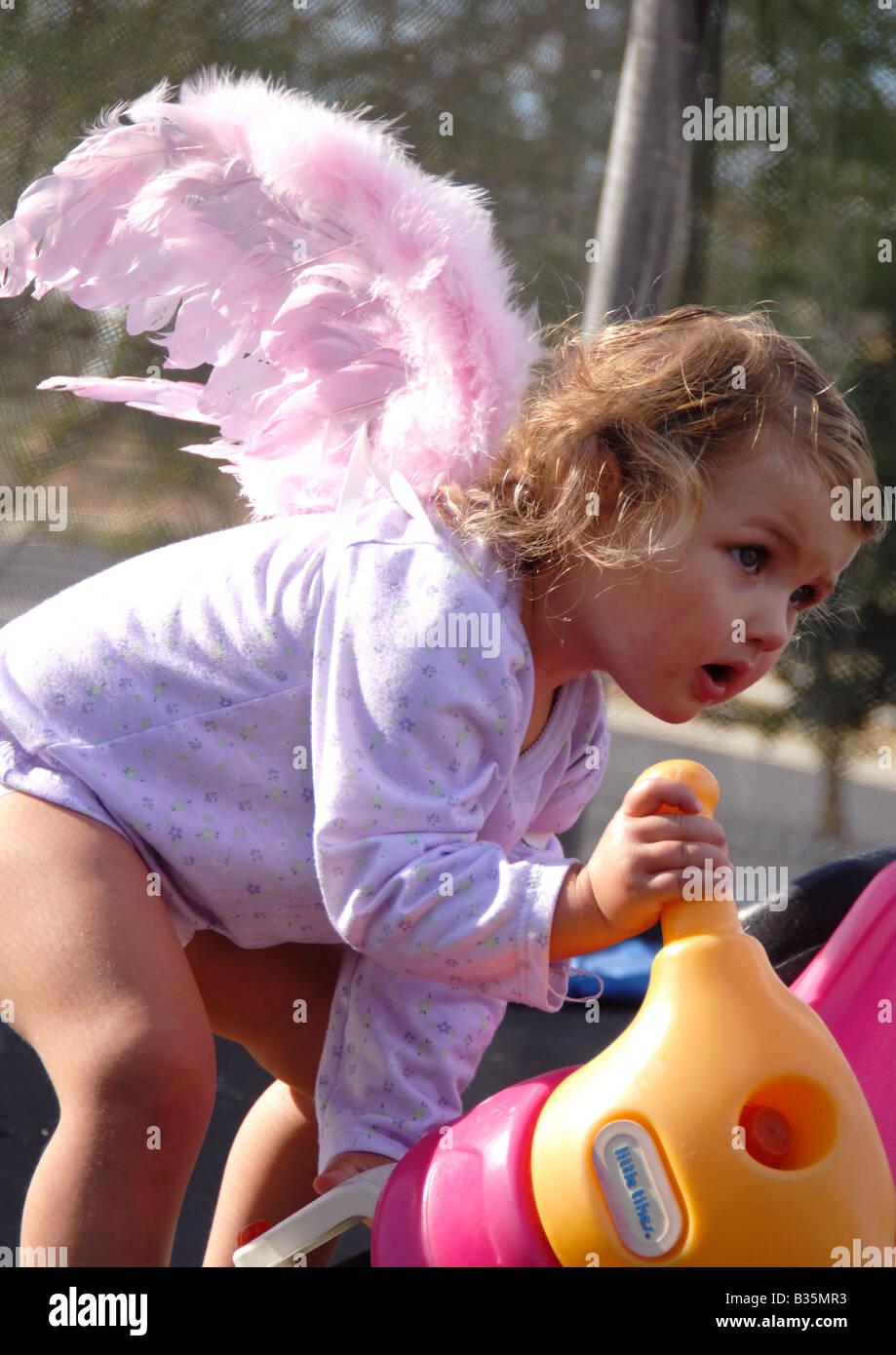 Standing holding childhood tricycle hi-res stock photography and images ...