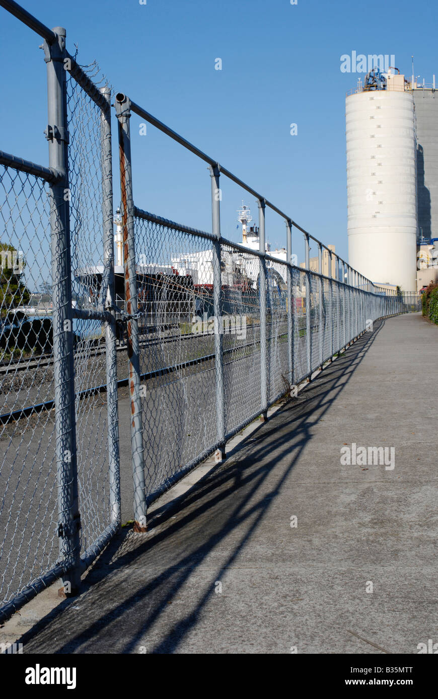 Security fence restricting access to an industrial area and railway ... Security fence restricting access to an industrial area and railway ...