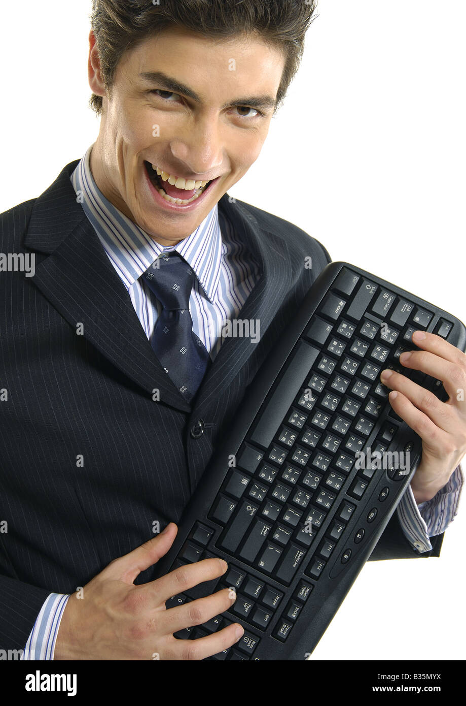 Portrait of a businessman holding a computer keyboard and laughing ...