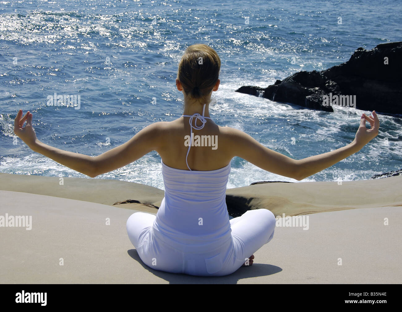Rear view of a woman practicing yoga Stock Photo - Alamy