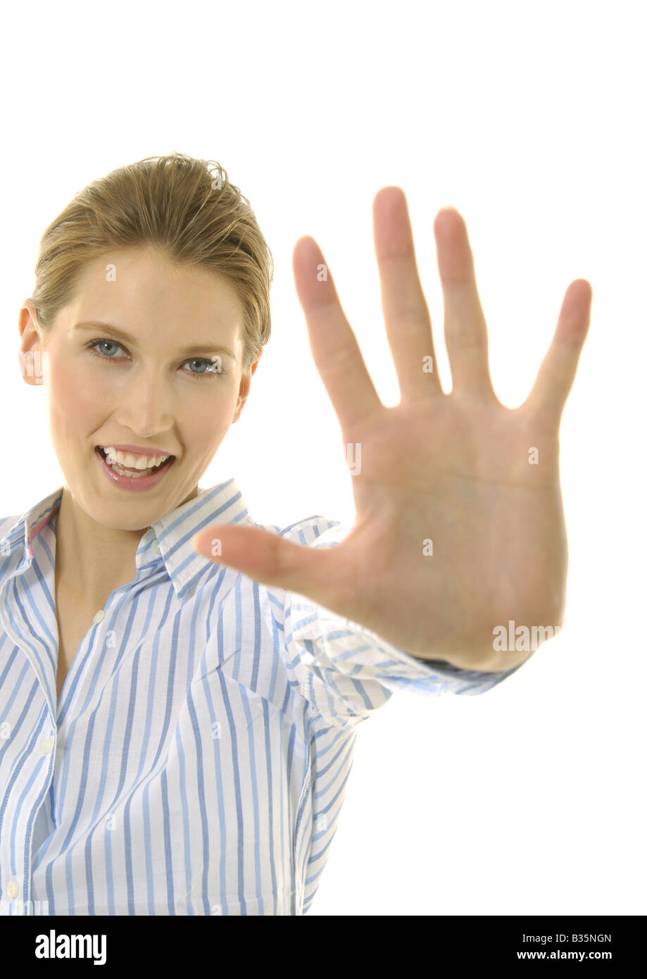 Portrait of a young woman making a stop gesture and smiling Stock Photo ...