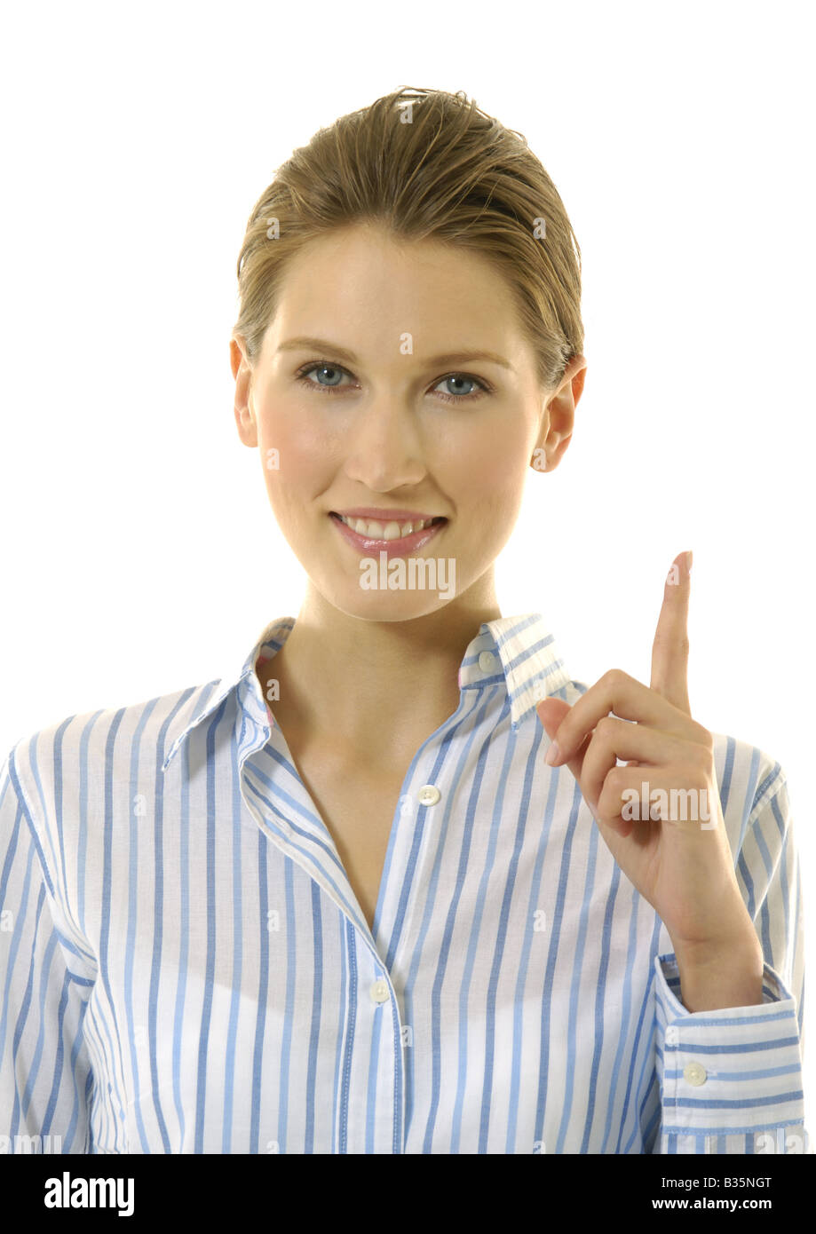 Portrait of a young woman pointing upwards Stock Photo - Alamy