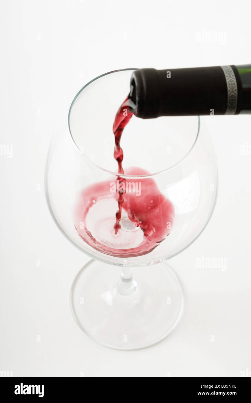 Red wine pouring into wine glass, close-up Stock Photo - Alamy
