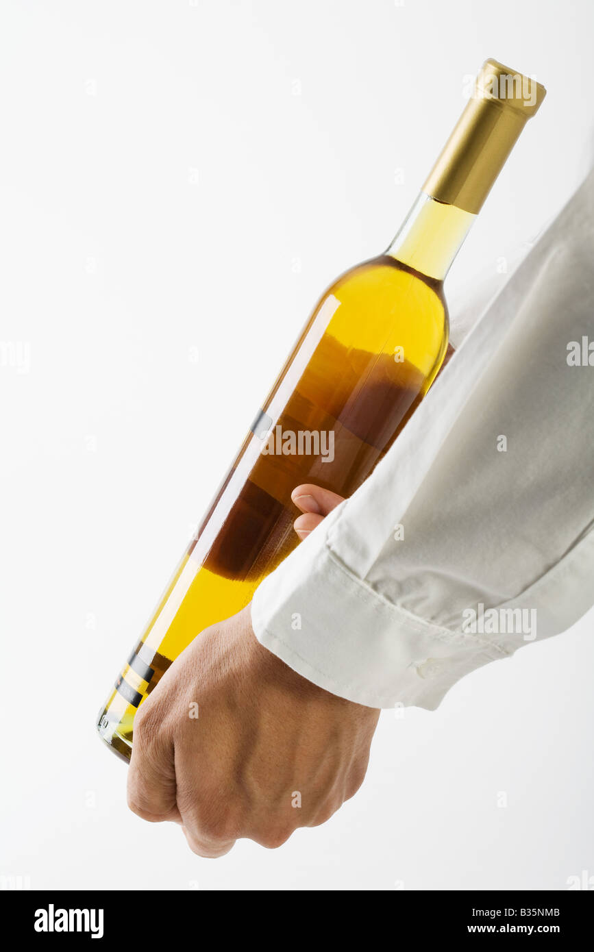 Man showing bottle of white wine, cropped view Stock Photo - Alamy
