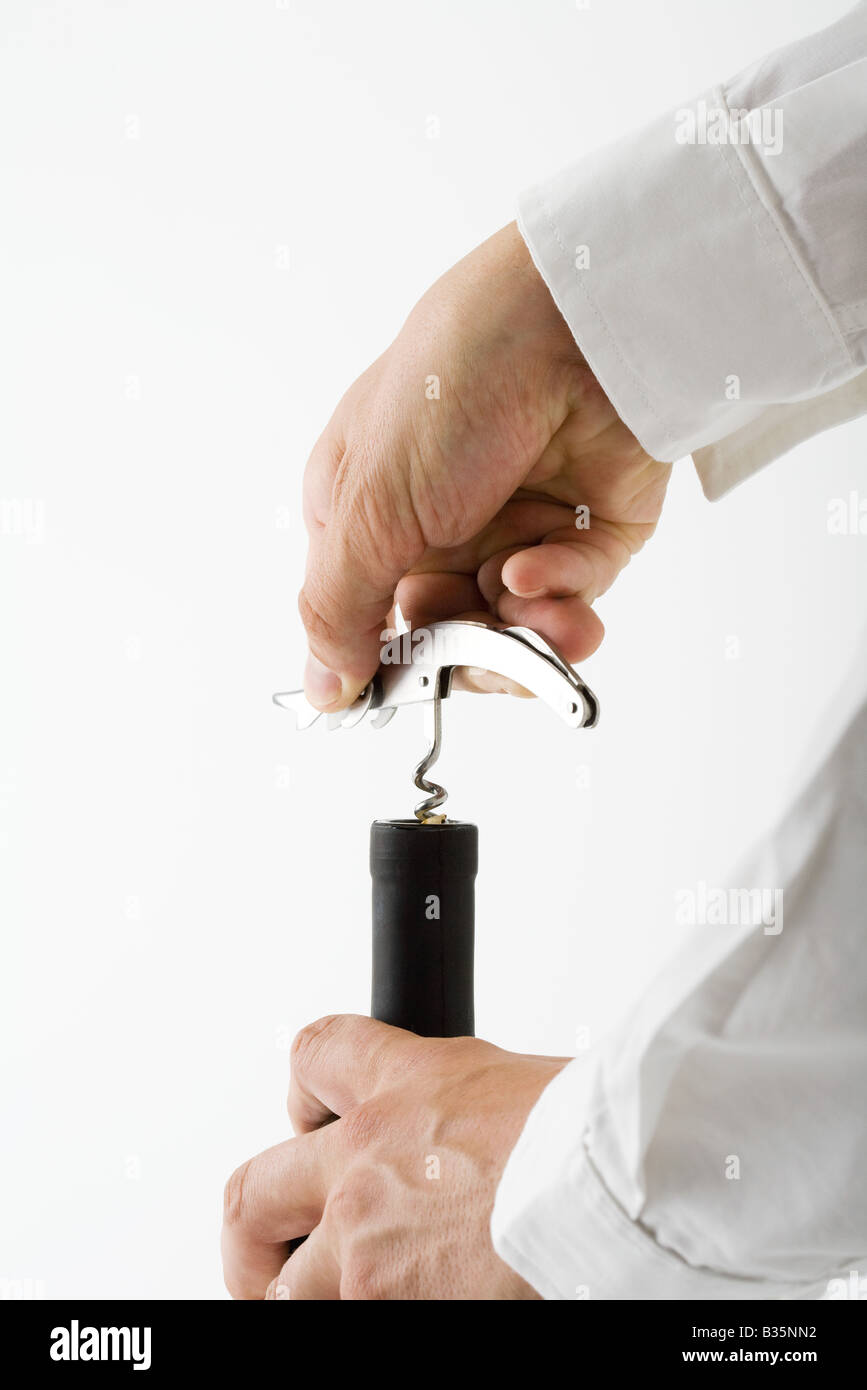 Man uncorking wine bottle, cropped view of hands Stock Photo - Alamy